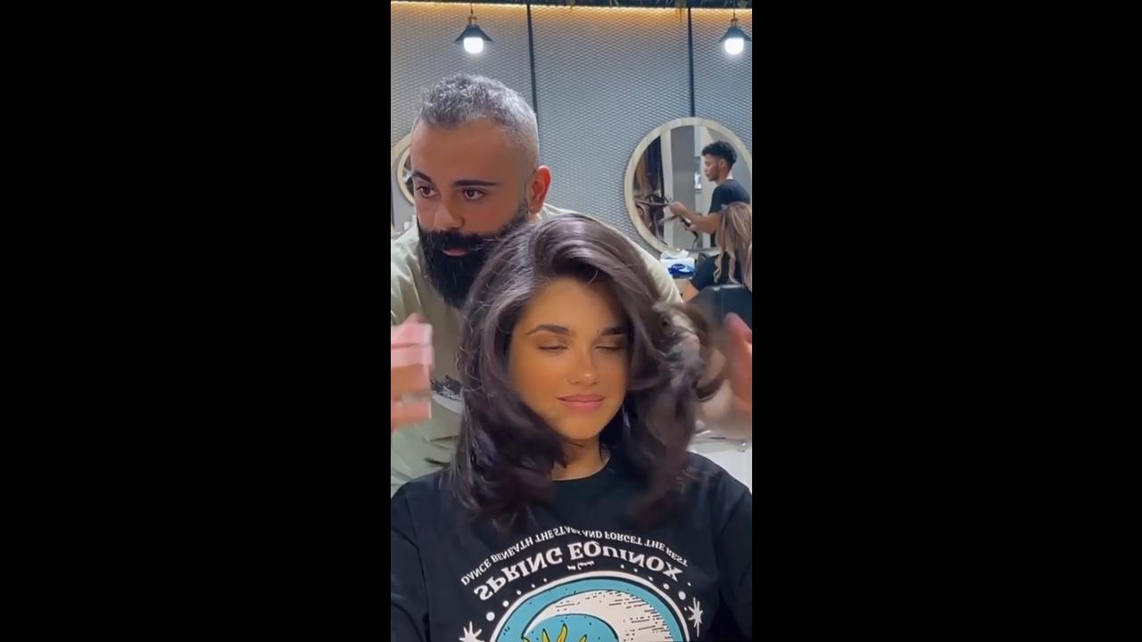 Styling shoulder length brunette hair with blow dry motion producing ...