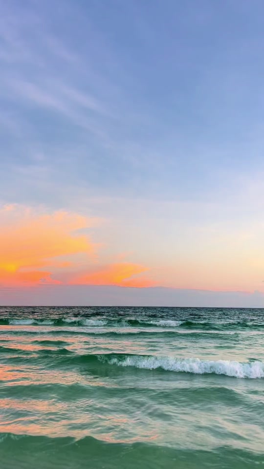 Calm ocean waves as the harvest moon begins to rise
