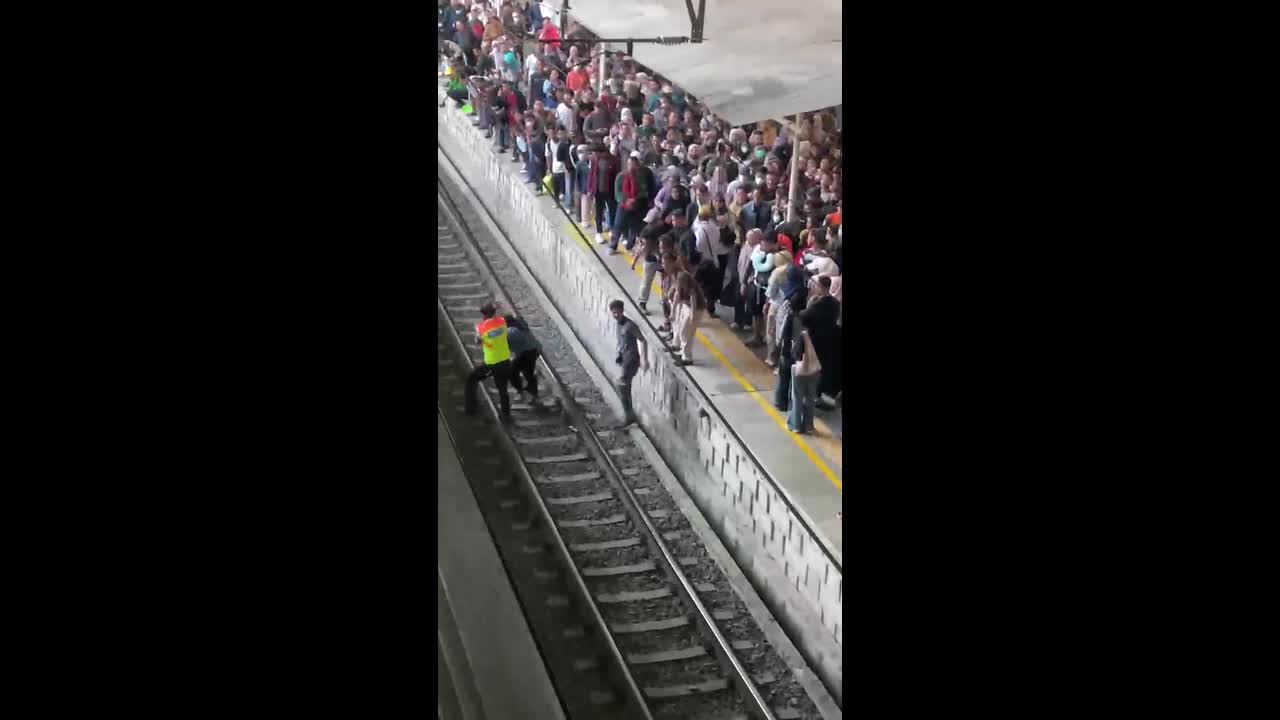 Passenger falls onto tracks at crowded train station in Indonesia