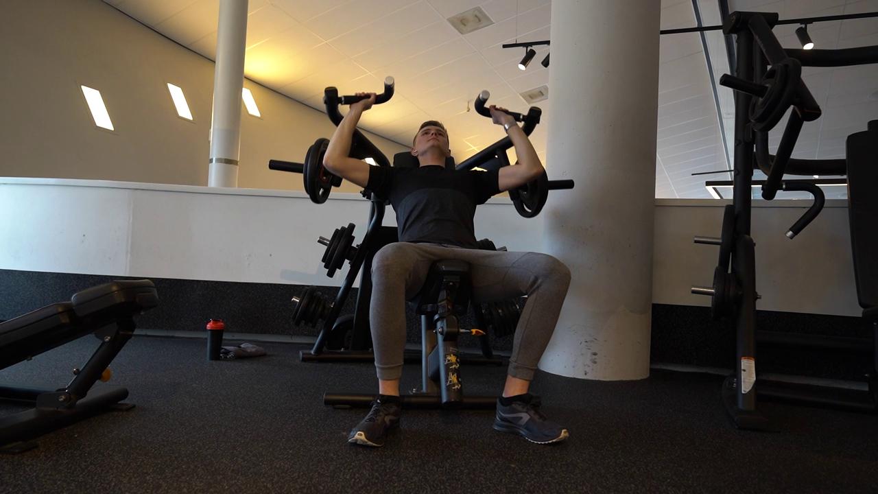 Putting light load on a chest workout at the gym