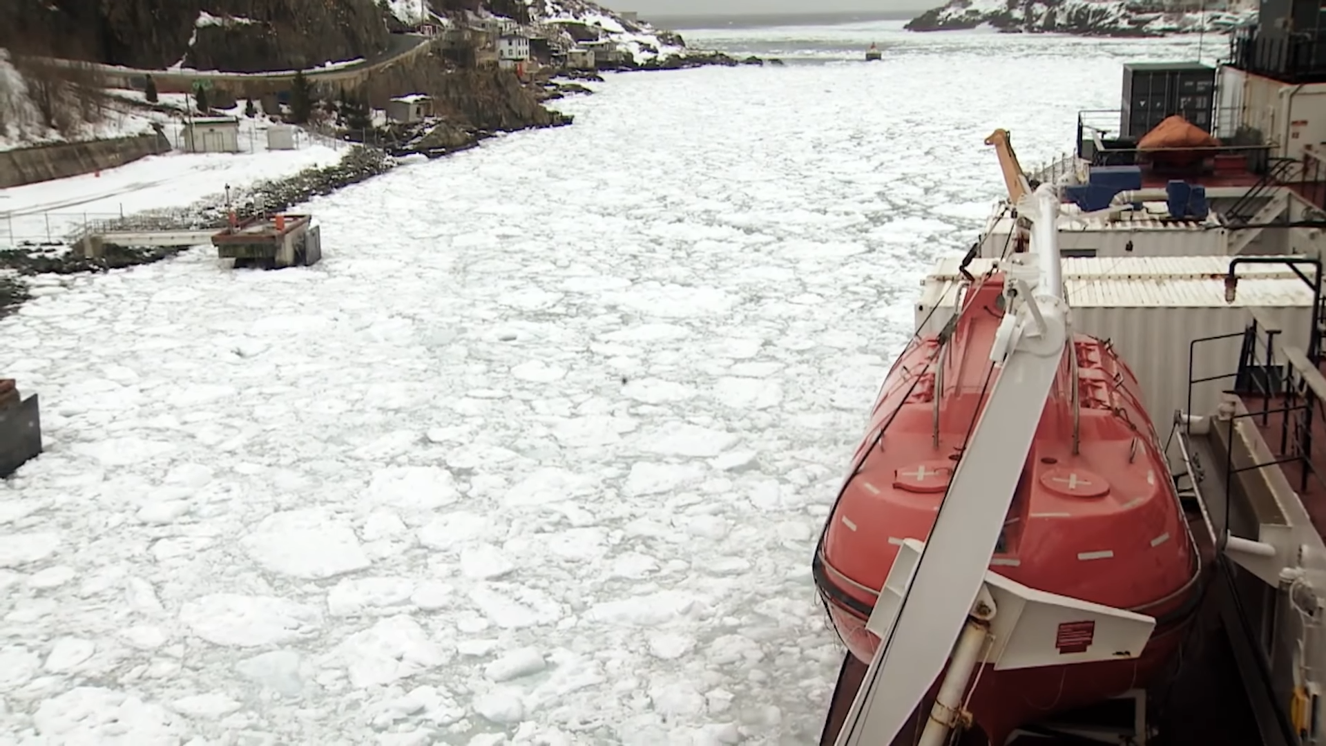 Watch an icebreaker smash through frozen water to reach a trapped ship