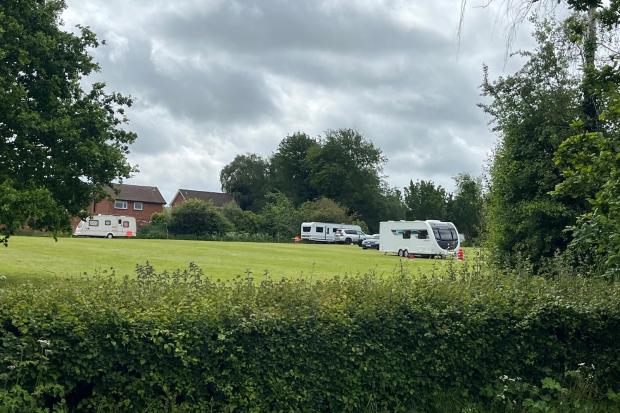 Large traveller encampment set up on outskirts of town
