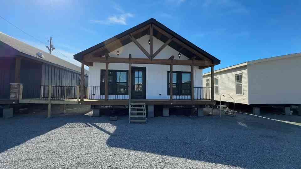 A mobile home with two 8-foot doors and a built-in porch fireplace ...