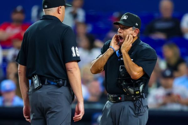Umpire Alfonso Marquez leaves after being struck by foul ball