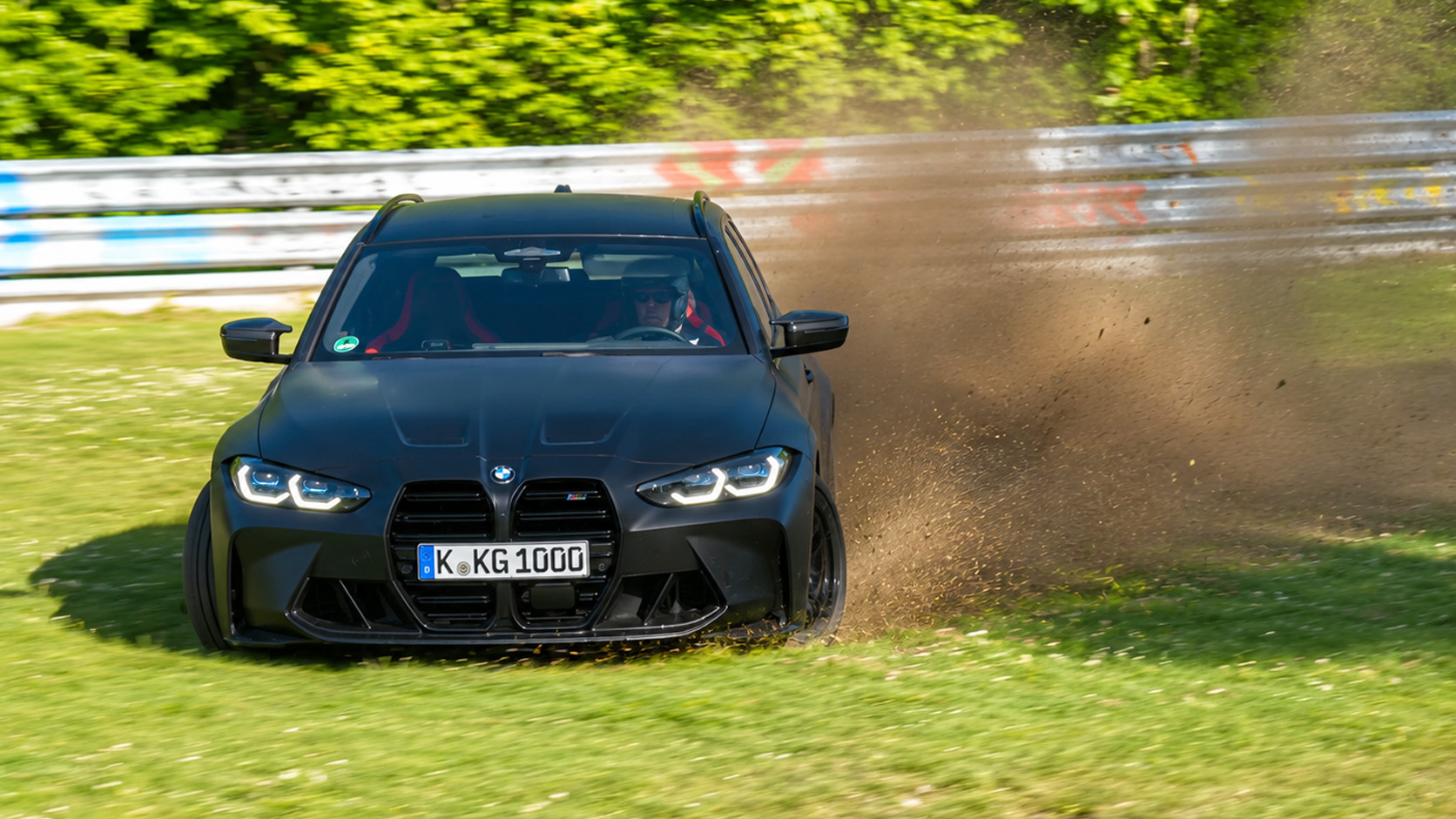 BMW driver loses control and drifts across the grass after going off track