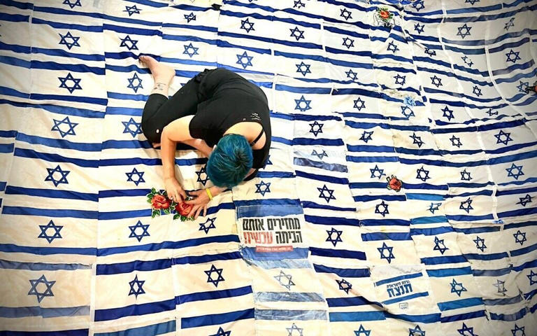 Using discarded Israeli flags, artist tries to stitch divided country ...