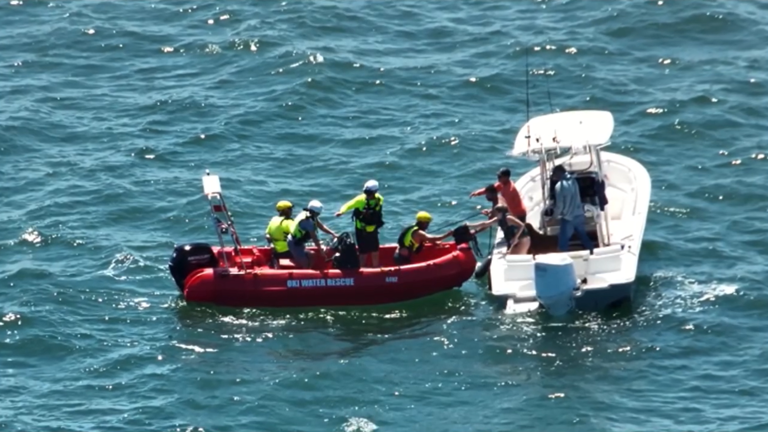 Four boaters and a dog rescued after boat capsizes near Oak Island