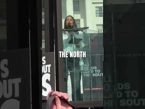 AOC talks tough while speaking behind bullet-proof glass