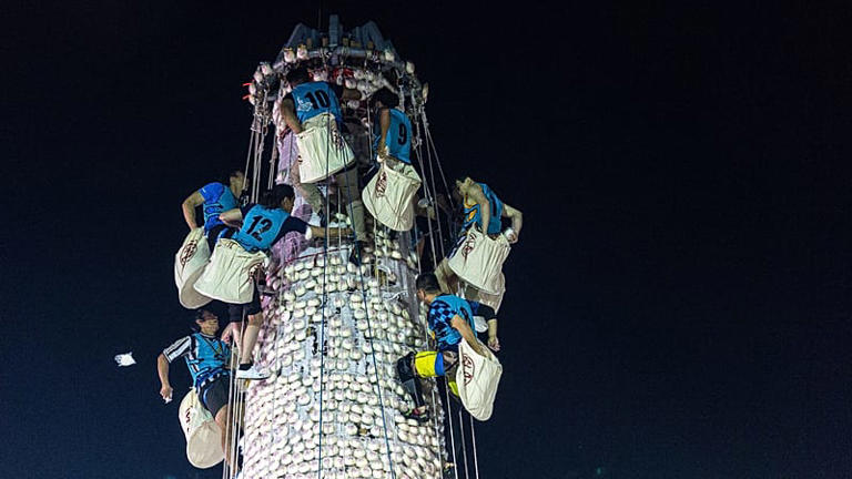 Climbers race up giant bun tower at Hong Kong’s colourful Bun Festival