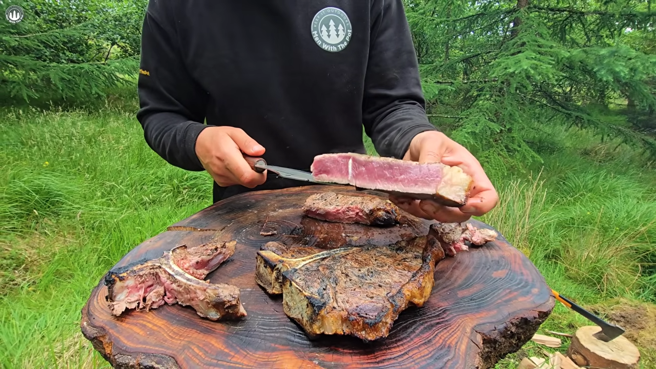 Watch how this steak dinner comes together over hot coals