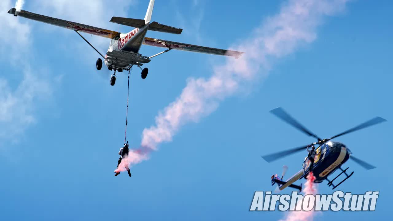Watch a man hang from an airplane during insane Red Bull stunts