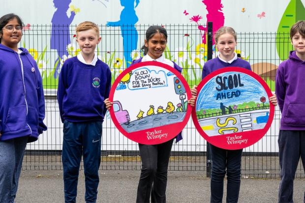 Road safety signs designed by pupils installed near new homes in South ...
