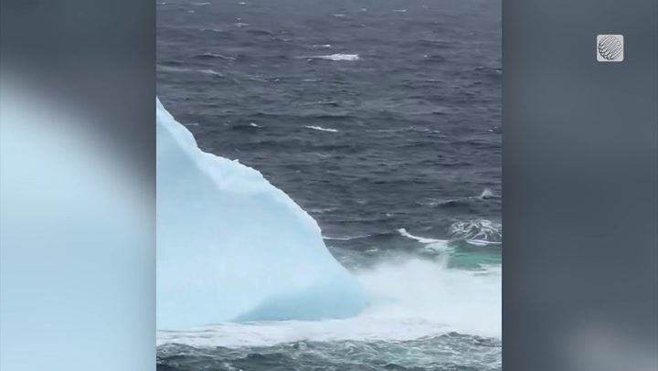 Large iceberg floats past the coast of Newfoundland