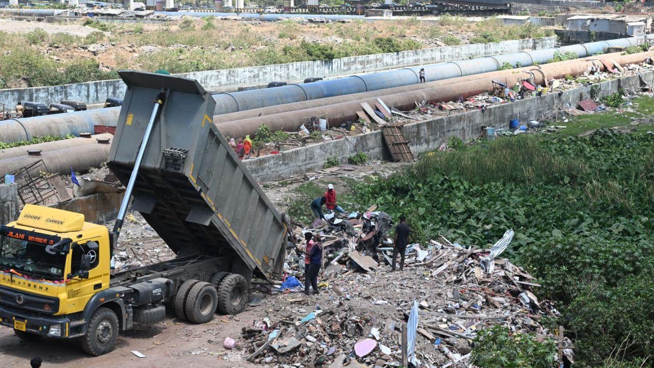In photos Garib Nagar cleanup begins as debris removal starts after ...