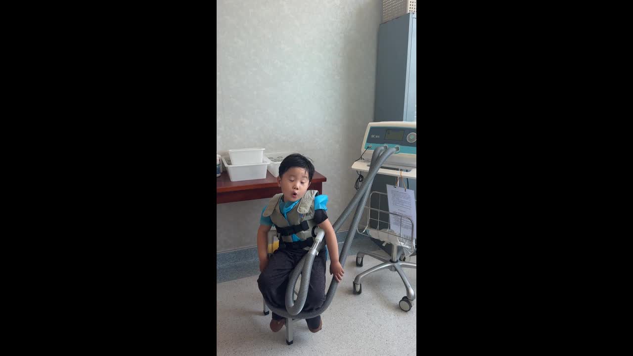 Boy makes funny sounds during chest wall oscillation therapy in ...