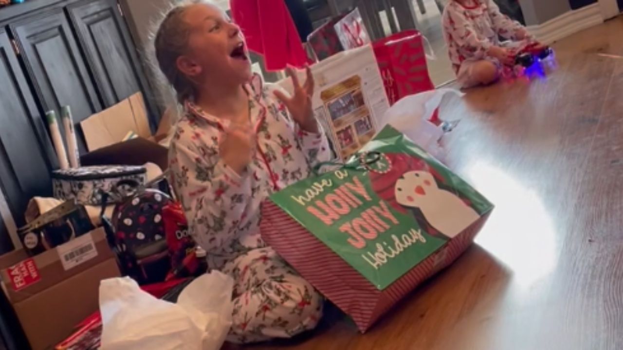 Lively gamer girl bubbles with happiness after being surprised with an ...