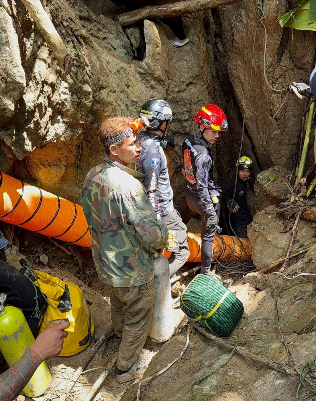 Rescuers race to reach 7 trapped in a Laos cave after flash floods ...
