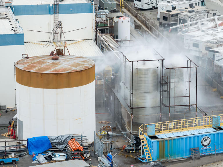 Thousands return home after chemical tank threat, but fears linger