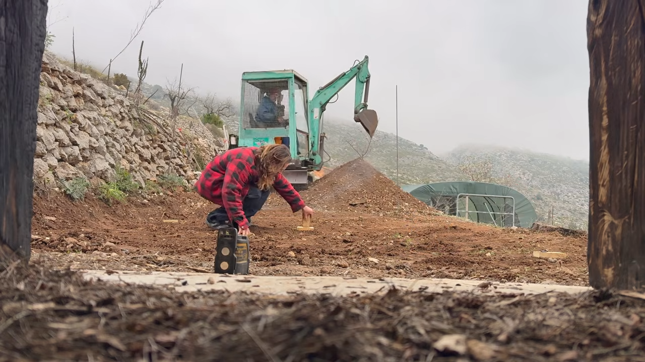 Heavy machinery flattening uneven ground