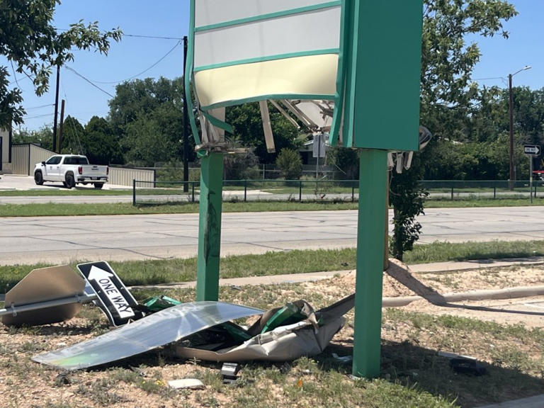 Driver claims blowout caused crash into signs, parked vehicles