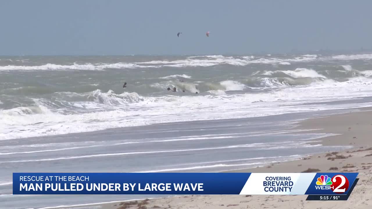 Bystanders rush into rough surf to save man pulled under by wave in ...