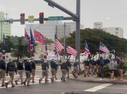 Group marches with US., Confederate and possibly Patriot Front flags