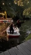 Woman jumps off boat and falls into water after losing balance