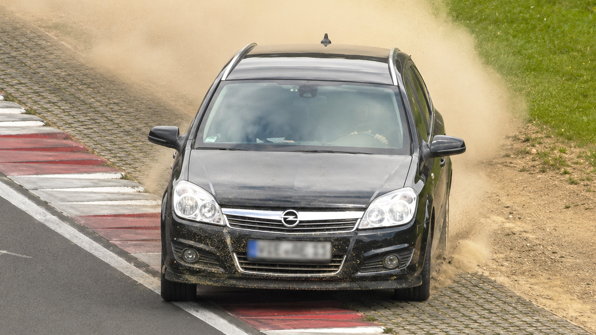 Drivers push ordinary cars hard through dangerous Green Hell corners