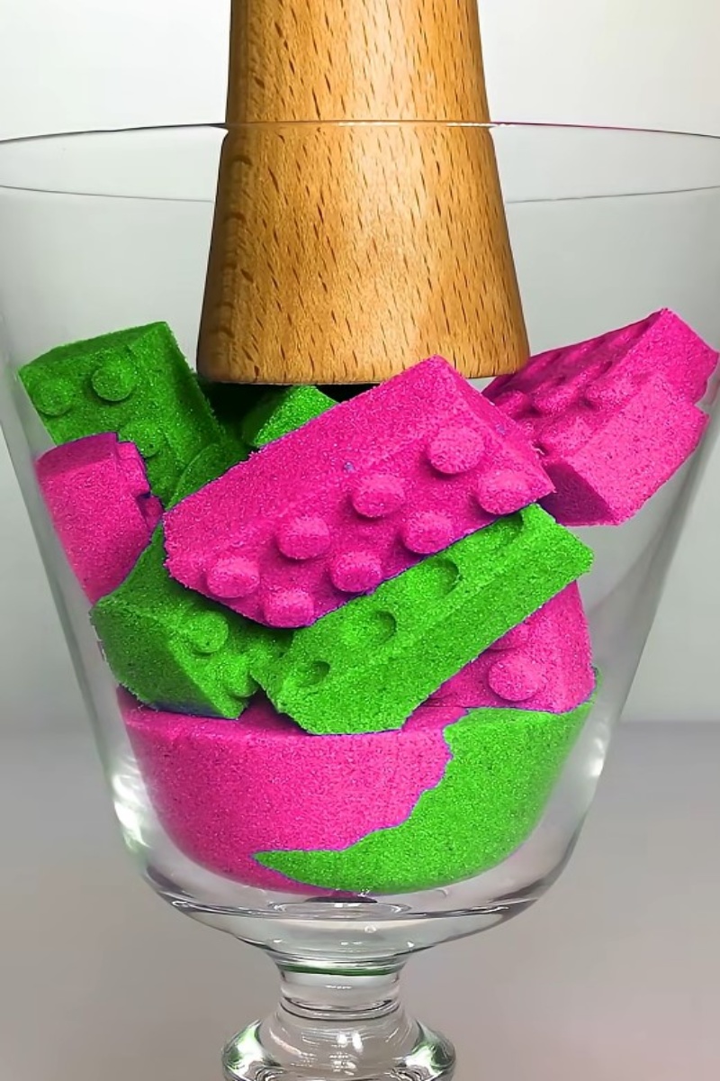 Vibrant sand art blocks in glass press