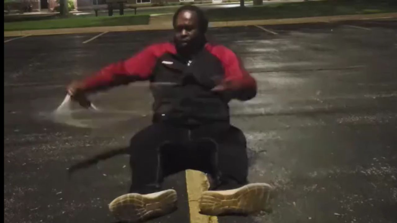 Man trains with jump rope in seated position in open lot setting
