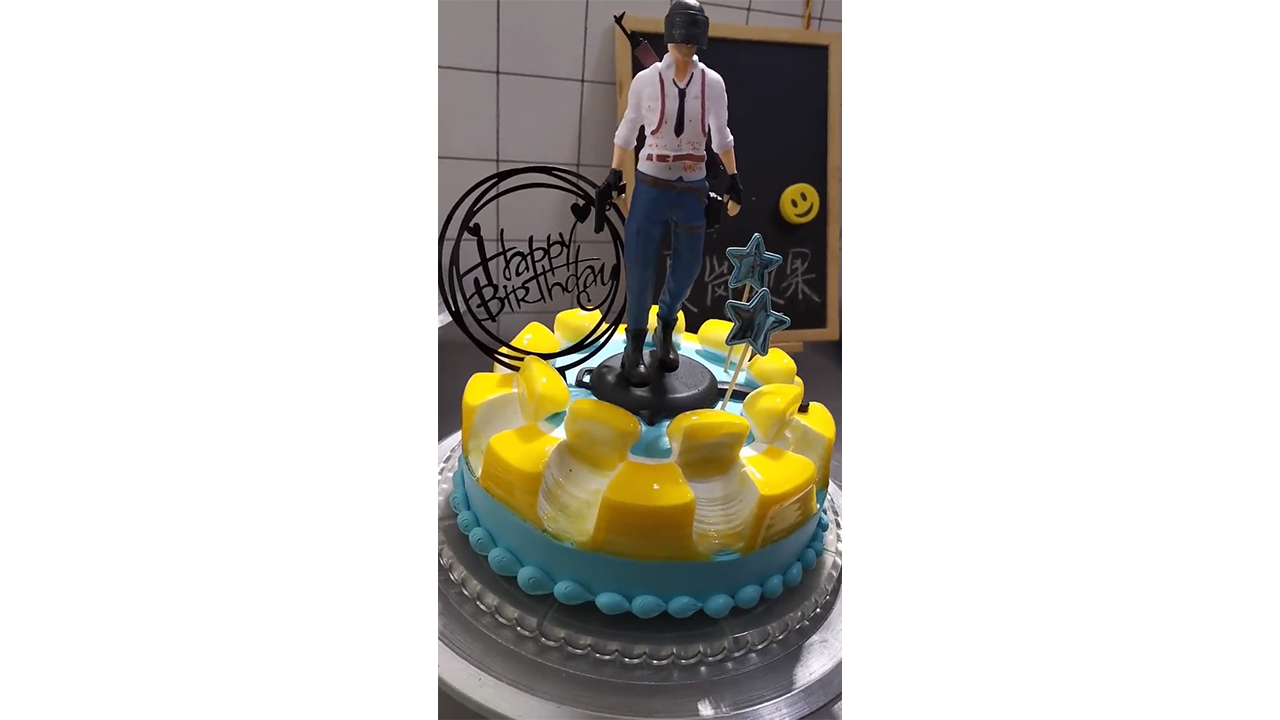 Decorating yellow and blue cream cake with PUBG character topper ...