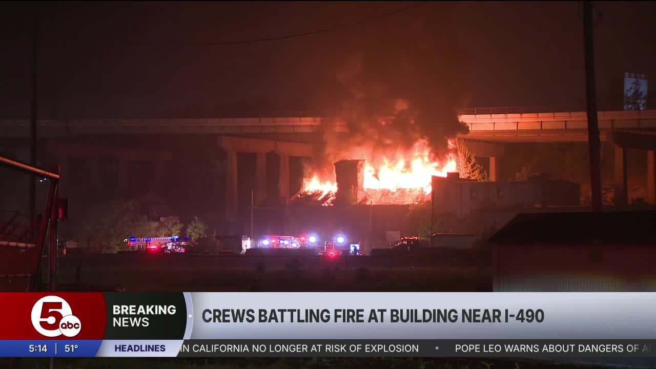 Crews battle massive fire at building near I-490