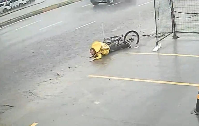 Delivery rider thrown from bike after hitting hidden pothole in flooded ...