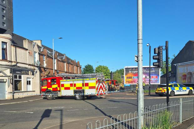 Firefighters battle four-hour blaze at local business as road taped off