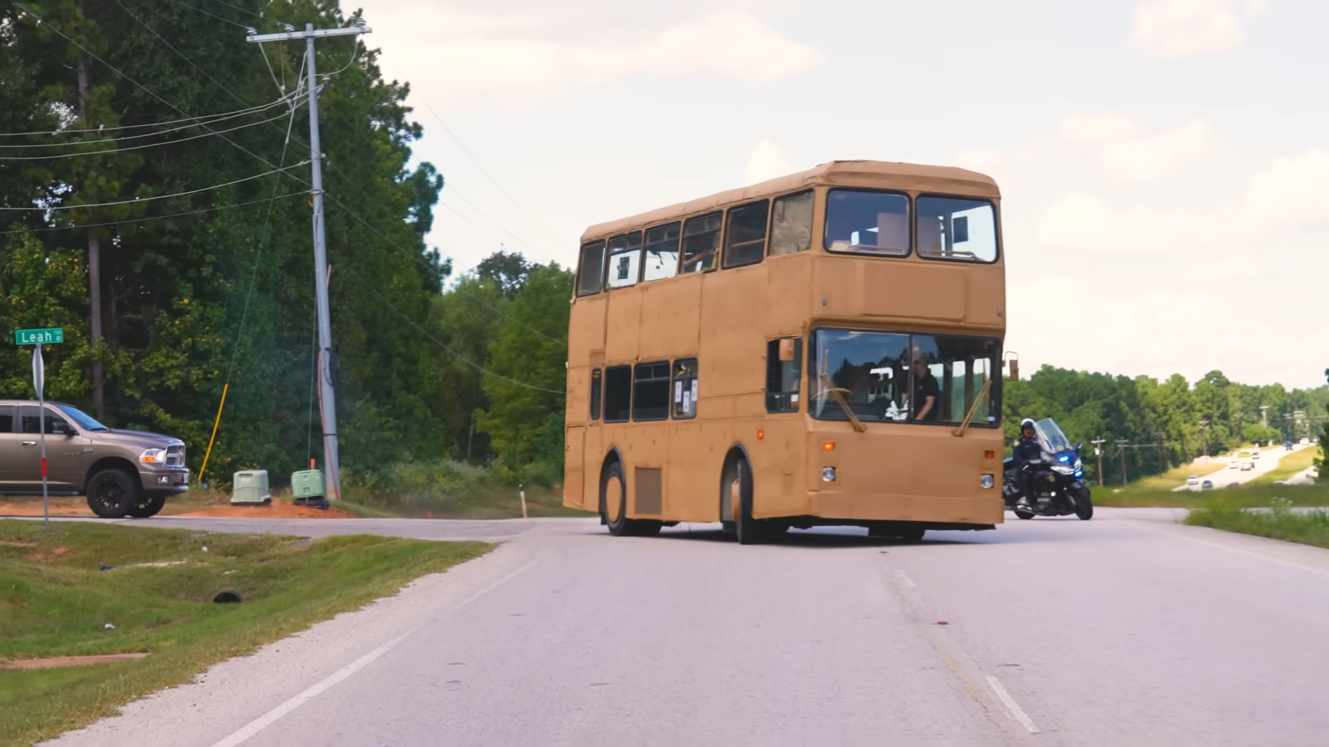 Watch how this two-story cardboard bus faces a road trip to destruction