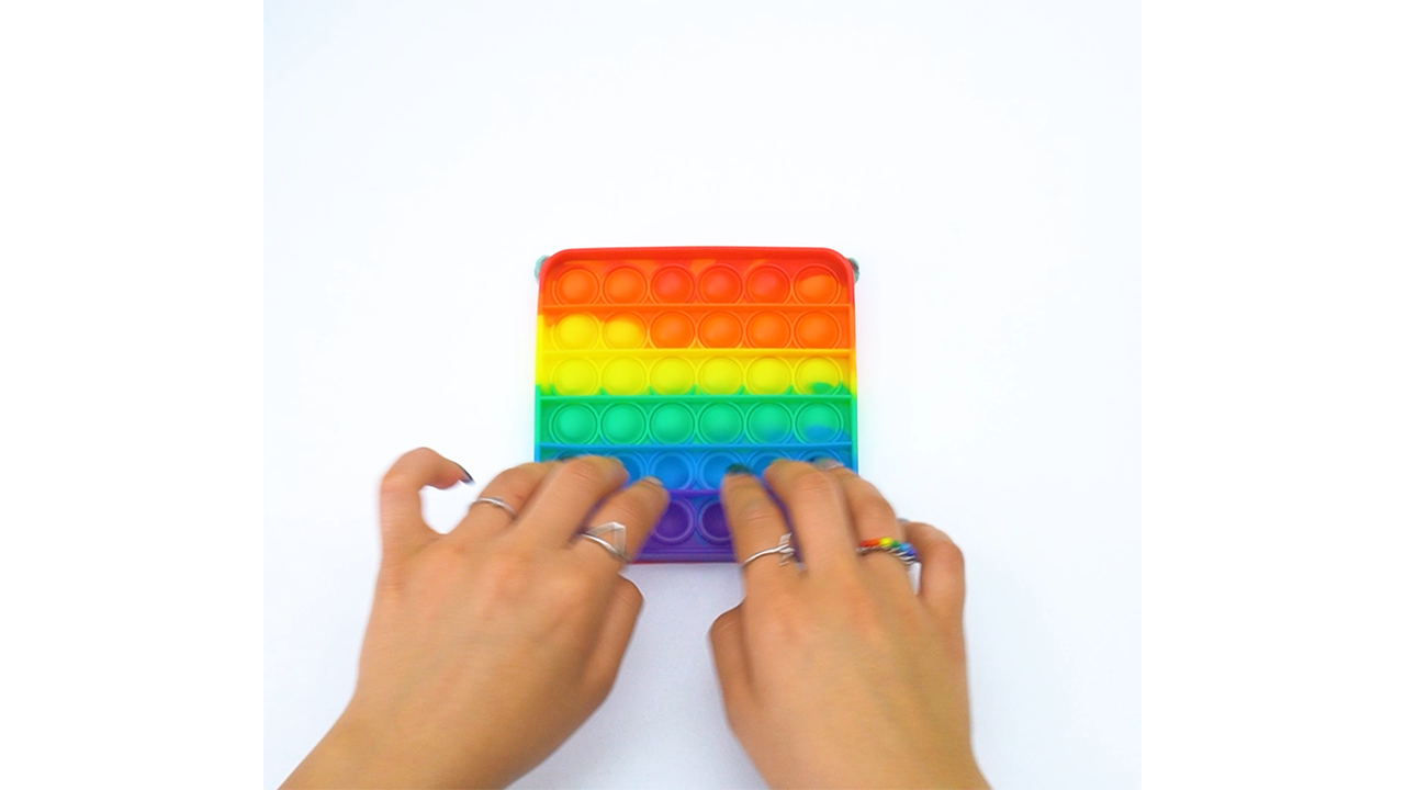 Popping a rainbow fidget toy with fast and satisfying bubble presses