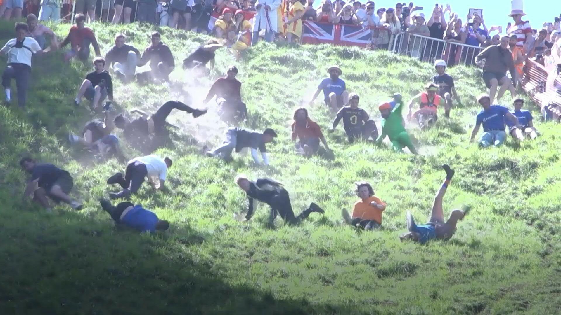 Thrill-seekers tumble to glory in 'bonkers' UK cheese-rolling race