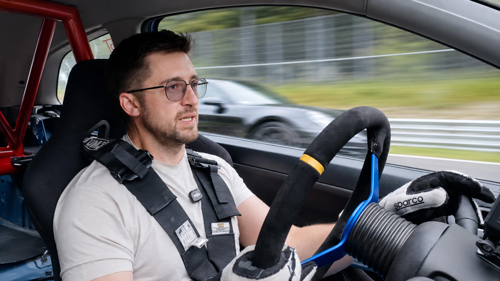 Inside a Fiesta ST150 Holding a Porsche 911 on Race Track