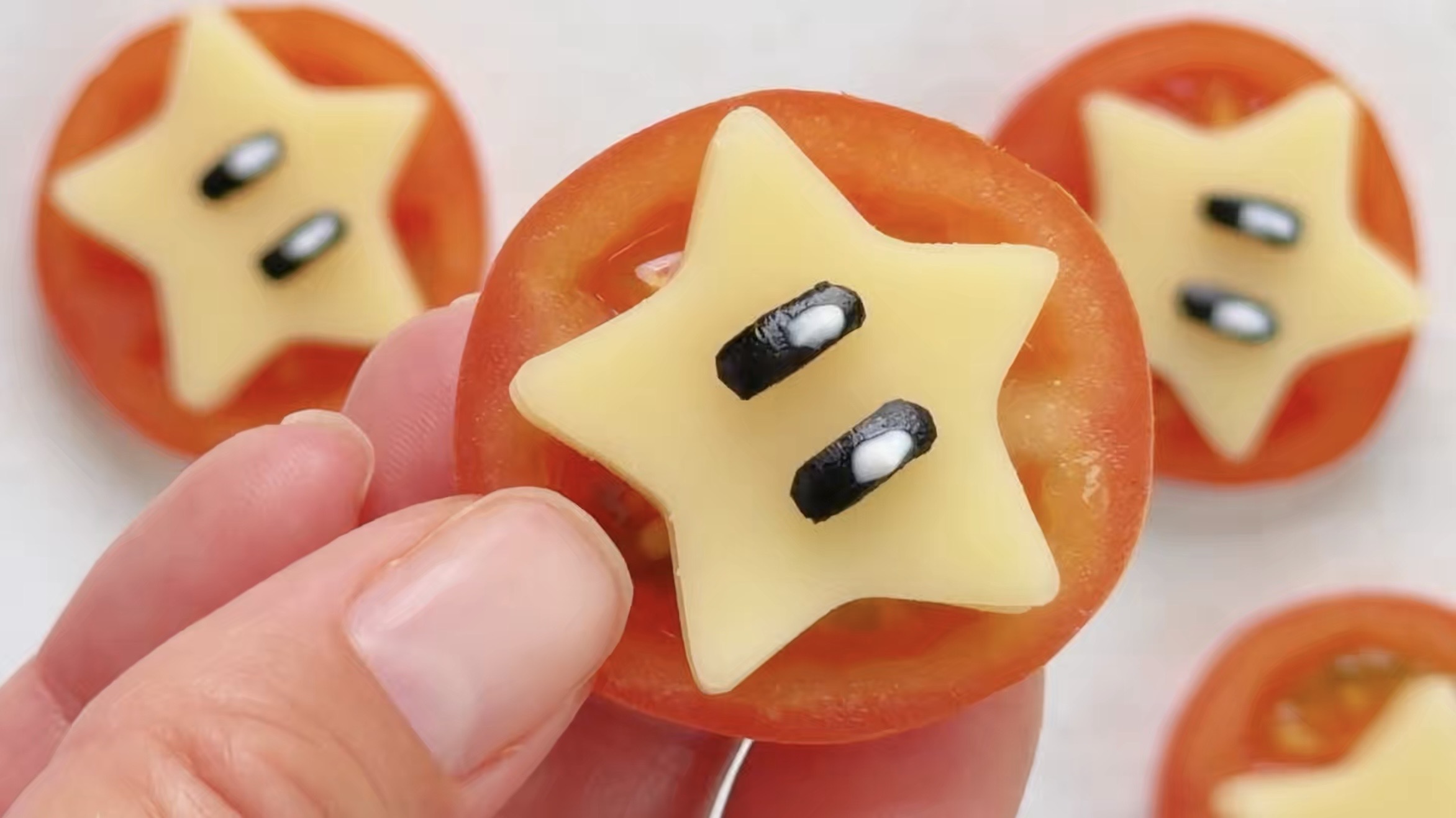 Cute Mario star snack bites made from cheese and tomatoes