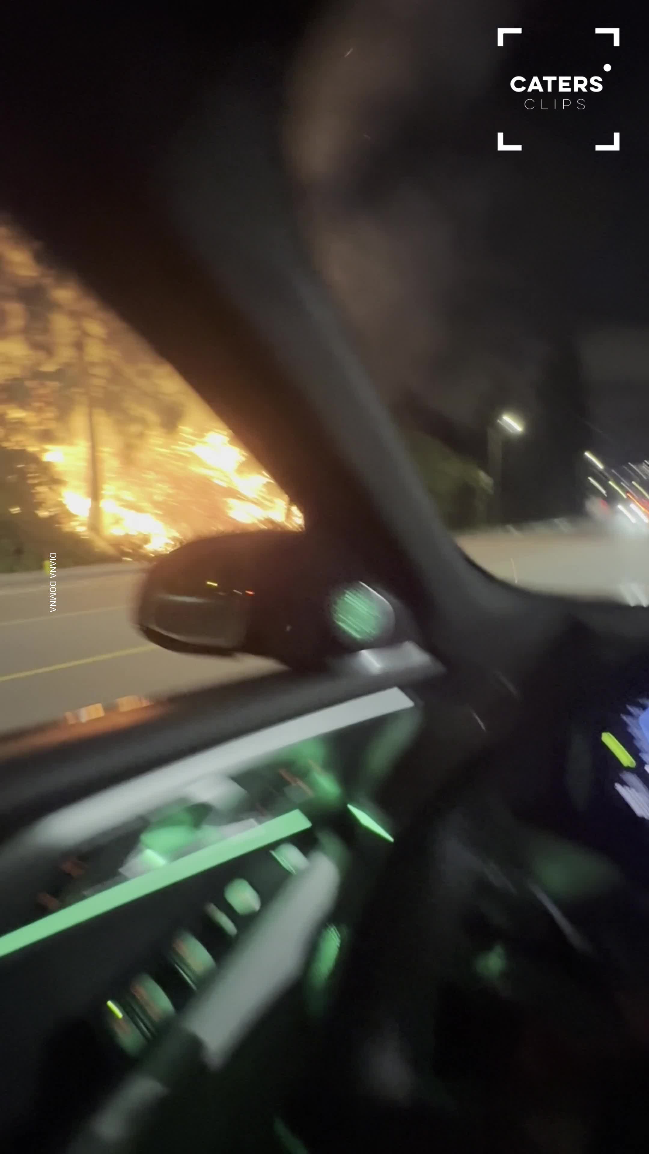 Roadside brush fire breaks out near Hollywood Hills apartment at night