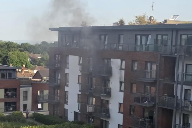Residents evacuated as smoke pours from high rise building
