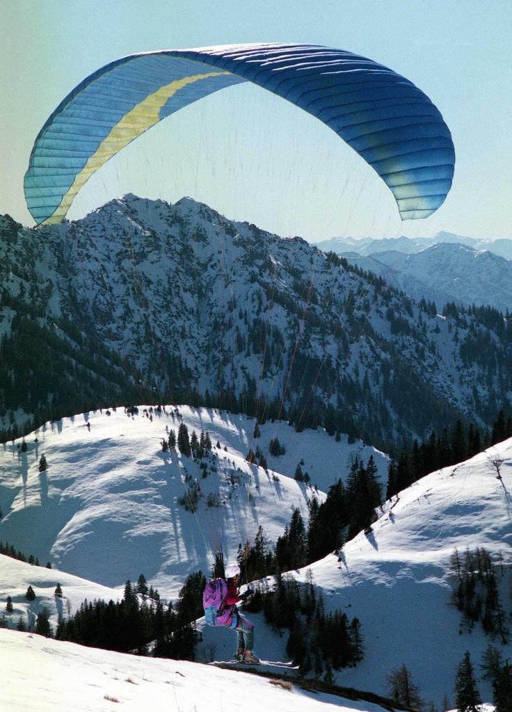 A small plane collides with a paraglider in mid-air