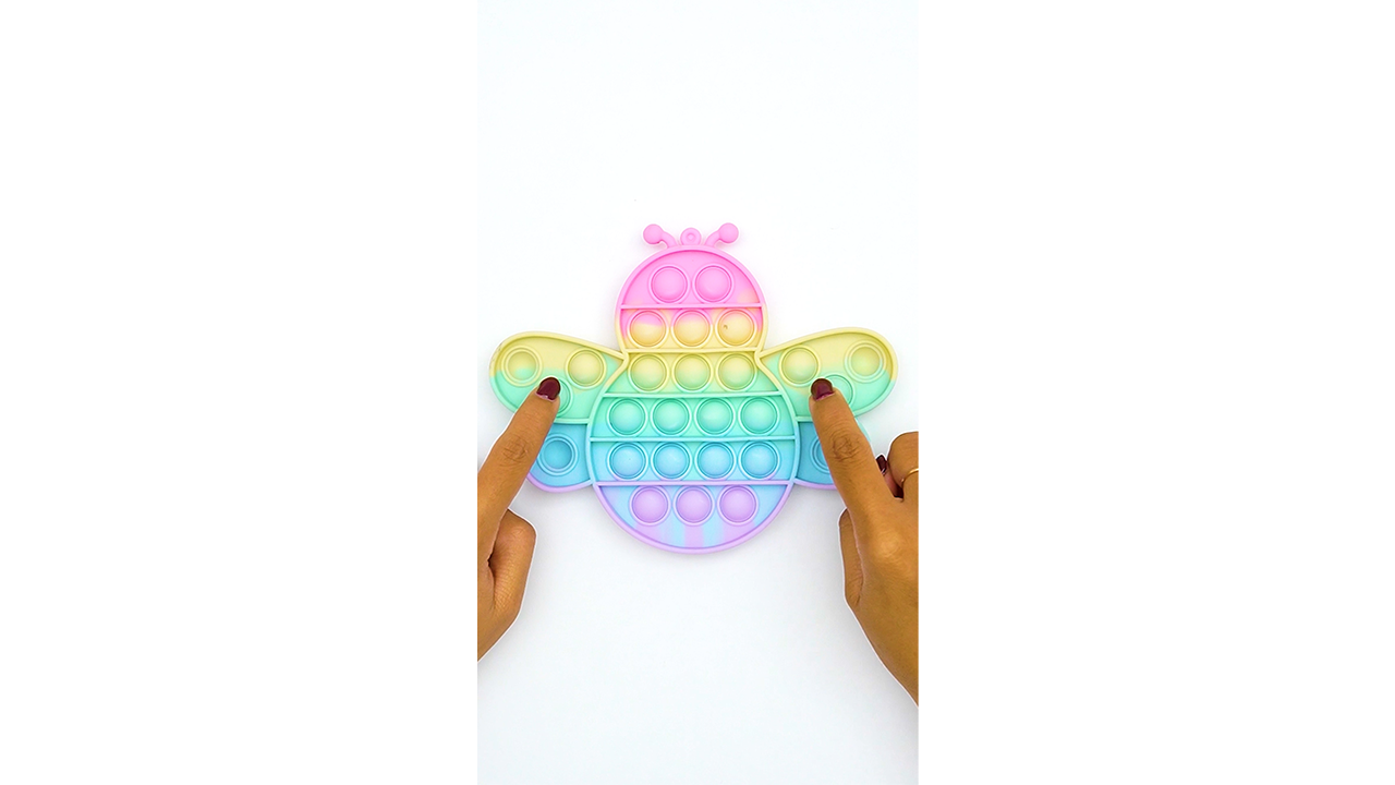 Pressing a pastel bee pop it with smooth bubble texture
