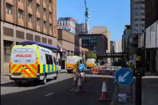Several police vans race through busy city centre street in response to ...