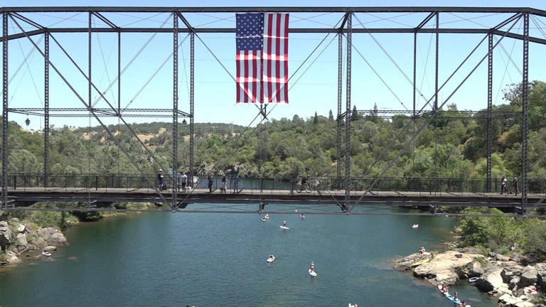 Folsom volunteer raises American flag on historic truss bridge