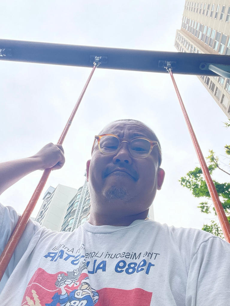 A grown adult on a swing