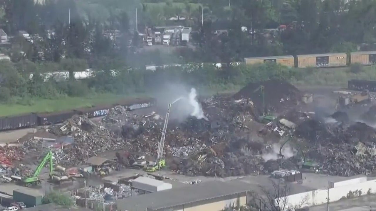 Opa-locka junkyard fire continues to smolder one day after blaze ...