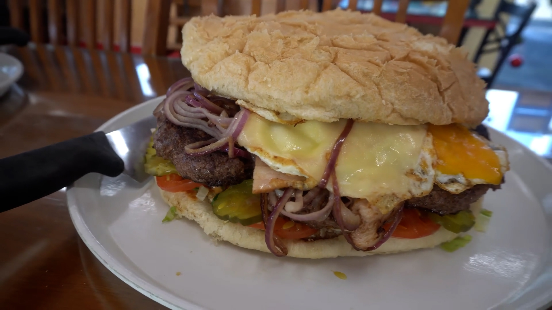 Man attempts burger challenge that's defeated over 1,000 people