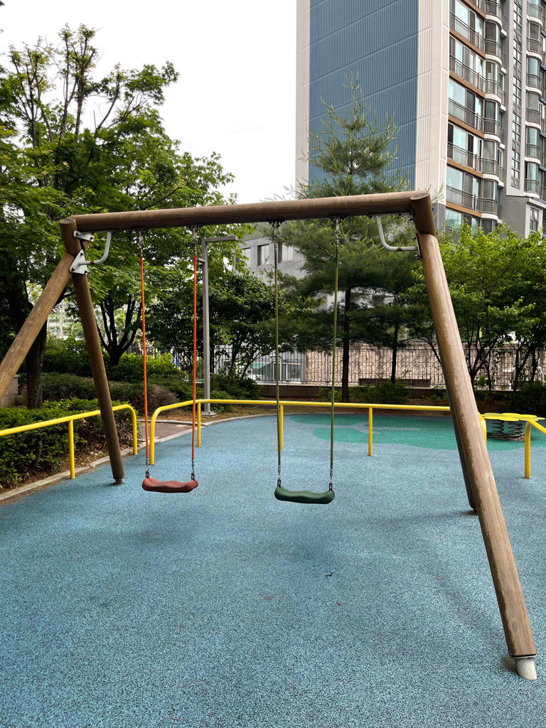 A grown adult on a swing