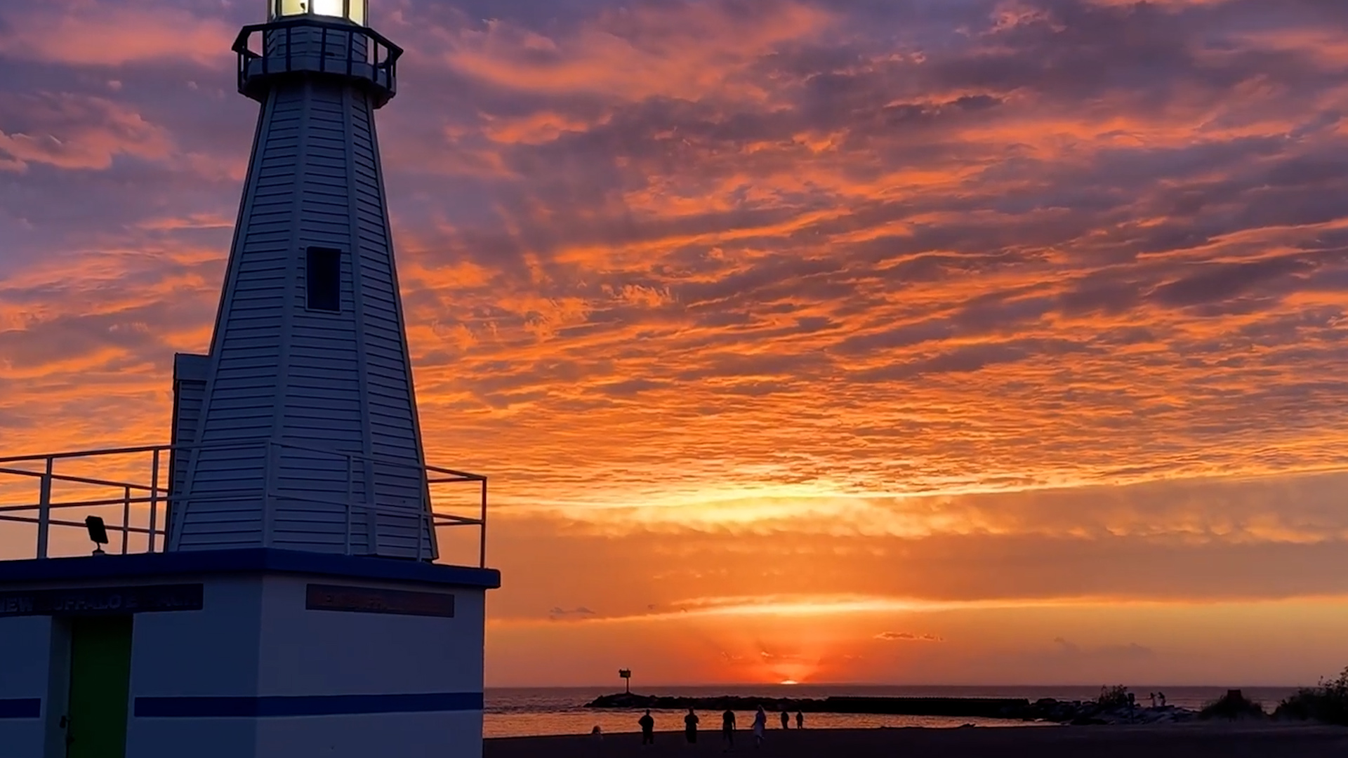 Fiery orange clouds create poetry over Michigan beach